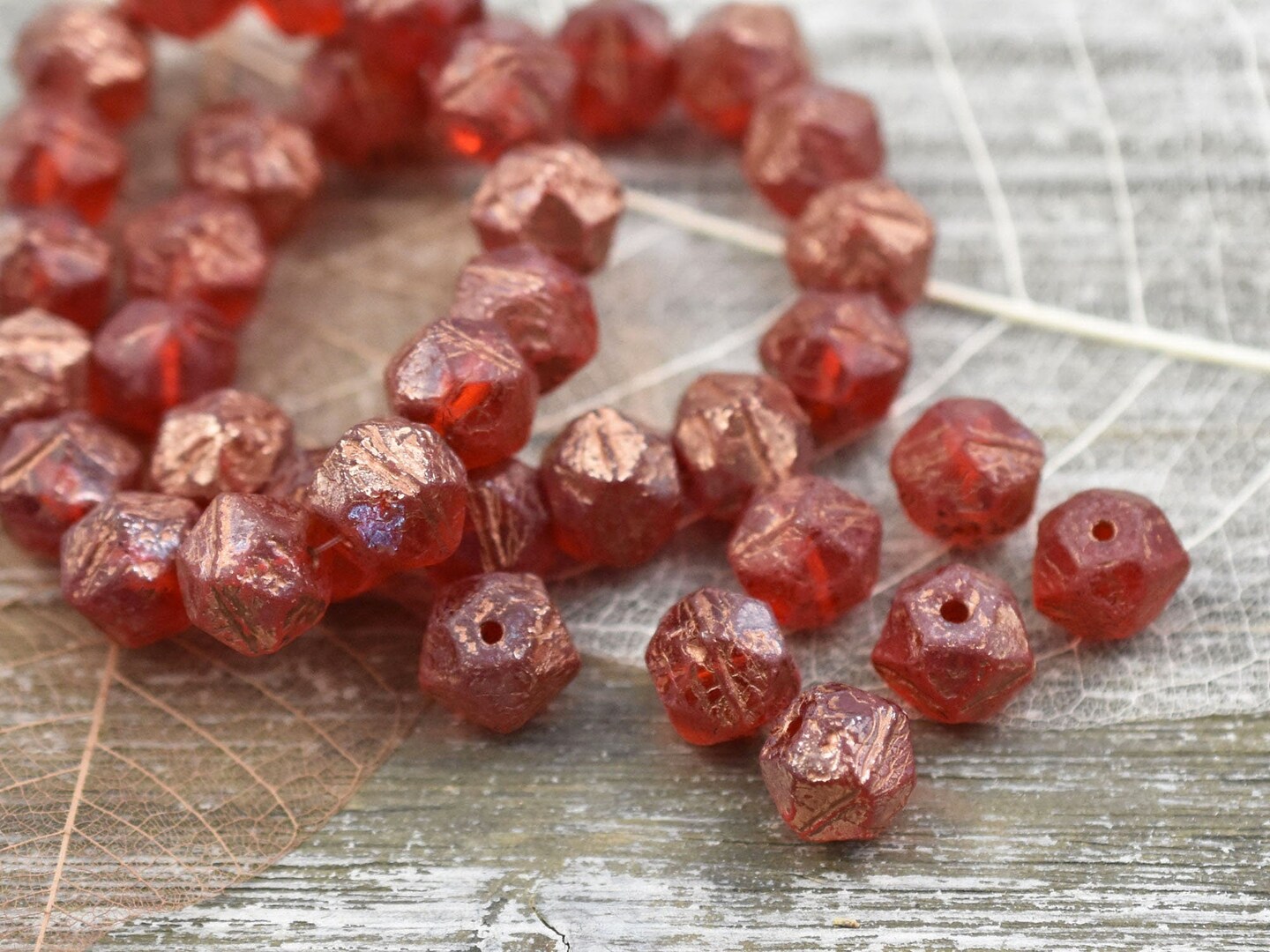 *10* 10mm Copper Washed Etched Ruby Red Antique Cut Round Beads | Michaels