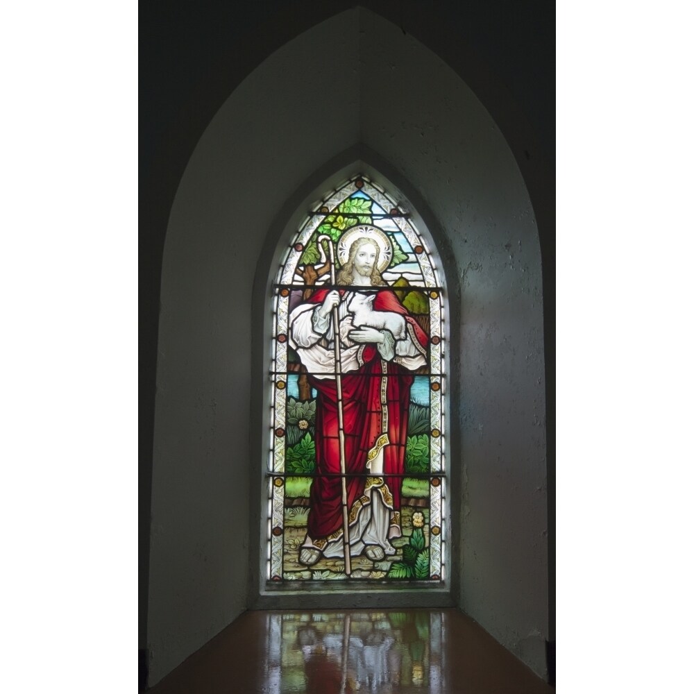 A Stained Glass Window Depicting Jesus Holding A Sheep At Church On The ...
