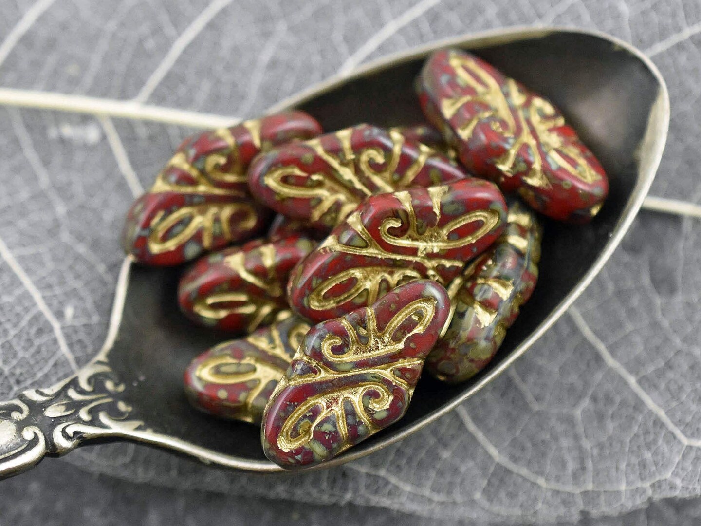 *9* 19x9mm Gold Washed Opaque Red Travertine Arabesque Beads | Michaels
