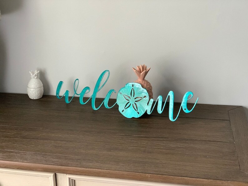 Metal Welcome Sand Dollar Sign, Powder Coated | MakerPlace by Michaels