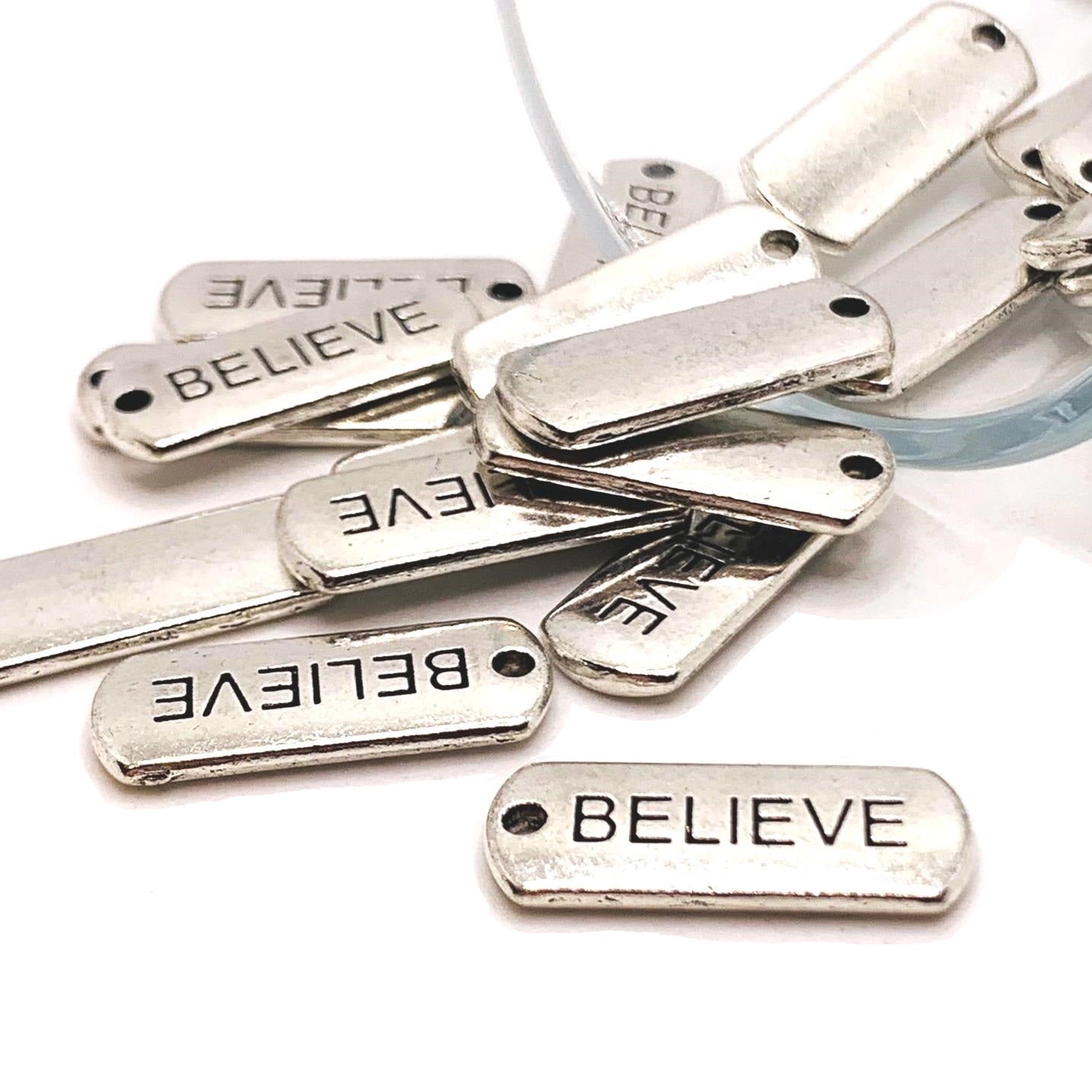 4, 20 or 50 Pieces: Silver Believe Word Bar Tag Charms | Michaels
